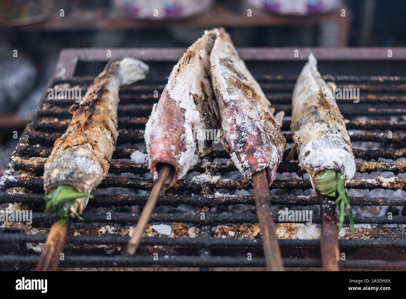 Salt-Crusted Grilled Snakehead fish grill on charcoal stove for sale at ...