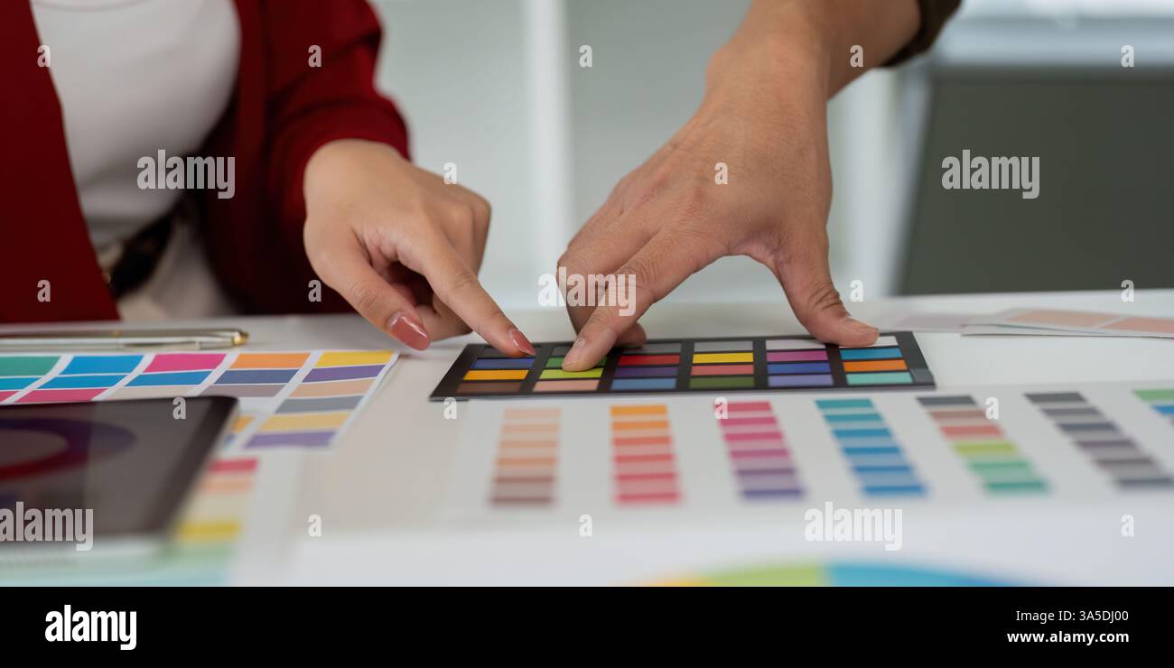 Graphic Design and Team Collaboration. Team members discuss color ...