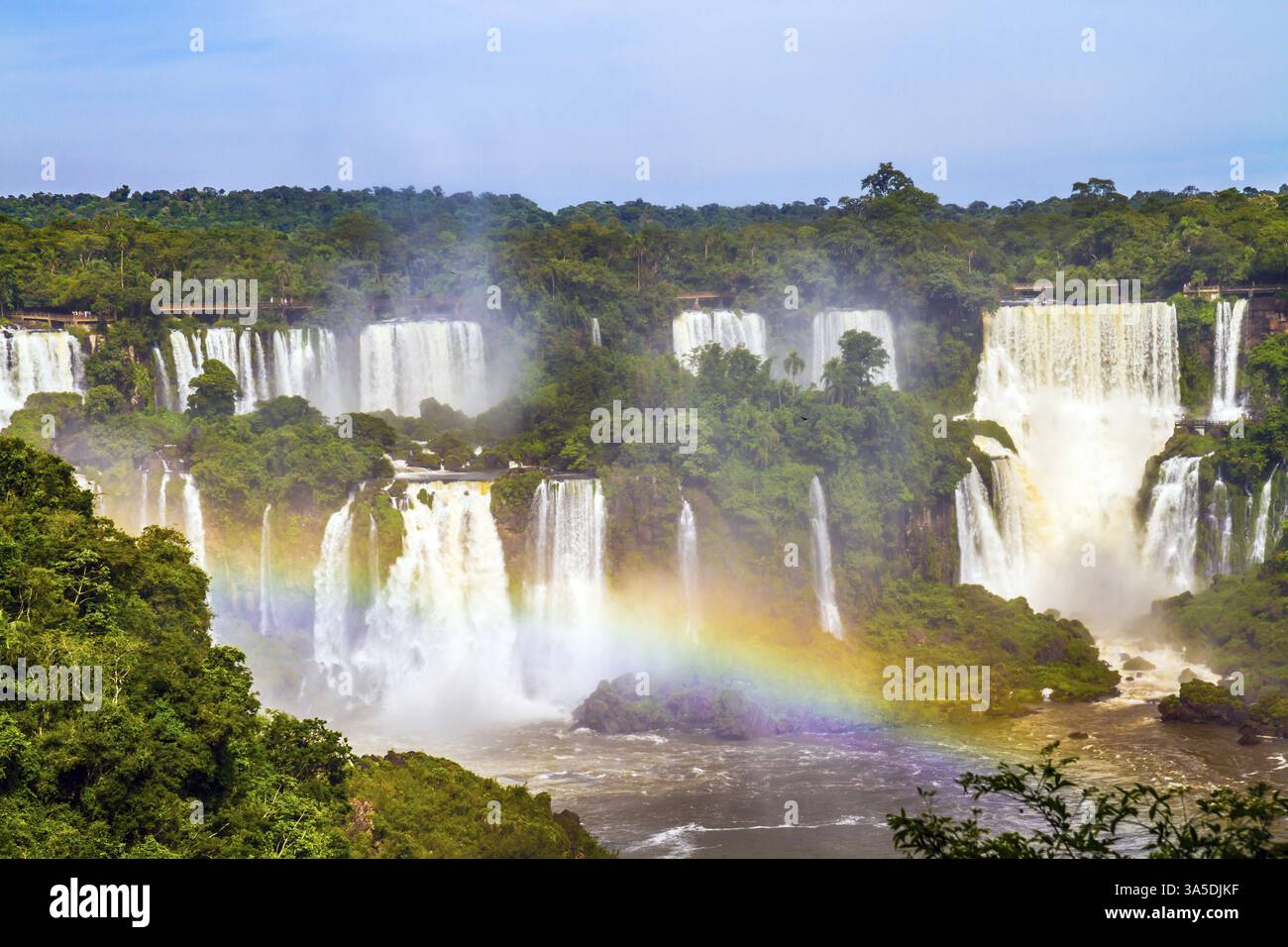 Powerful waterfall creates watery dust and a rainbow. Several ...