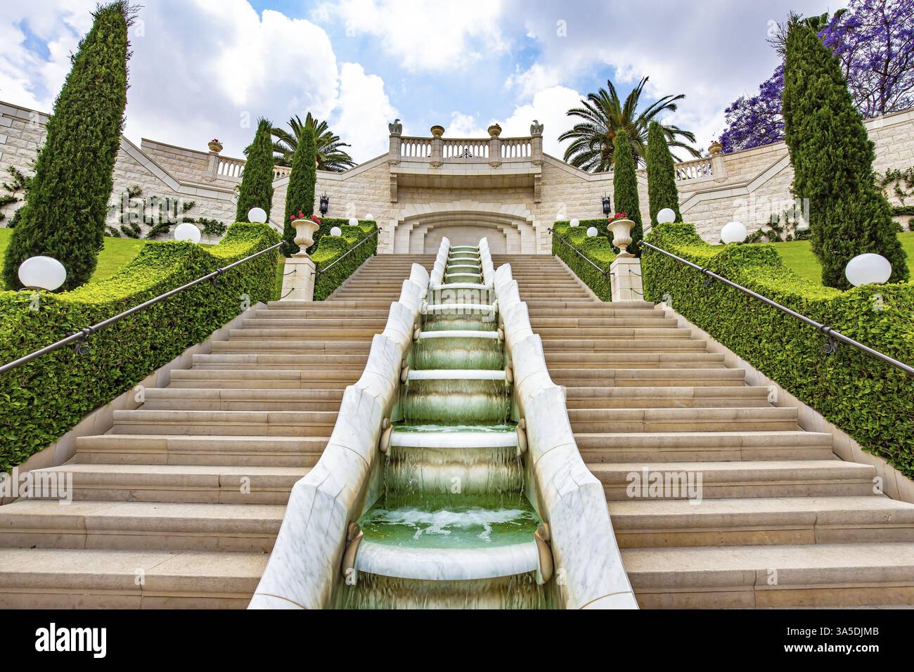 Picturesque cascade waterfall fountain. Marble staircase around the ...