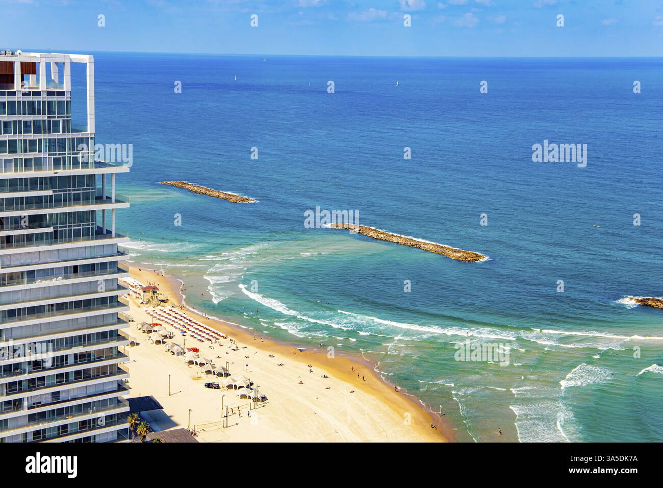 The blue waters of the Mediterranean attract tourists. Breakwaters ...
