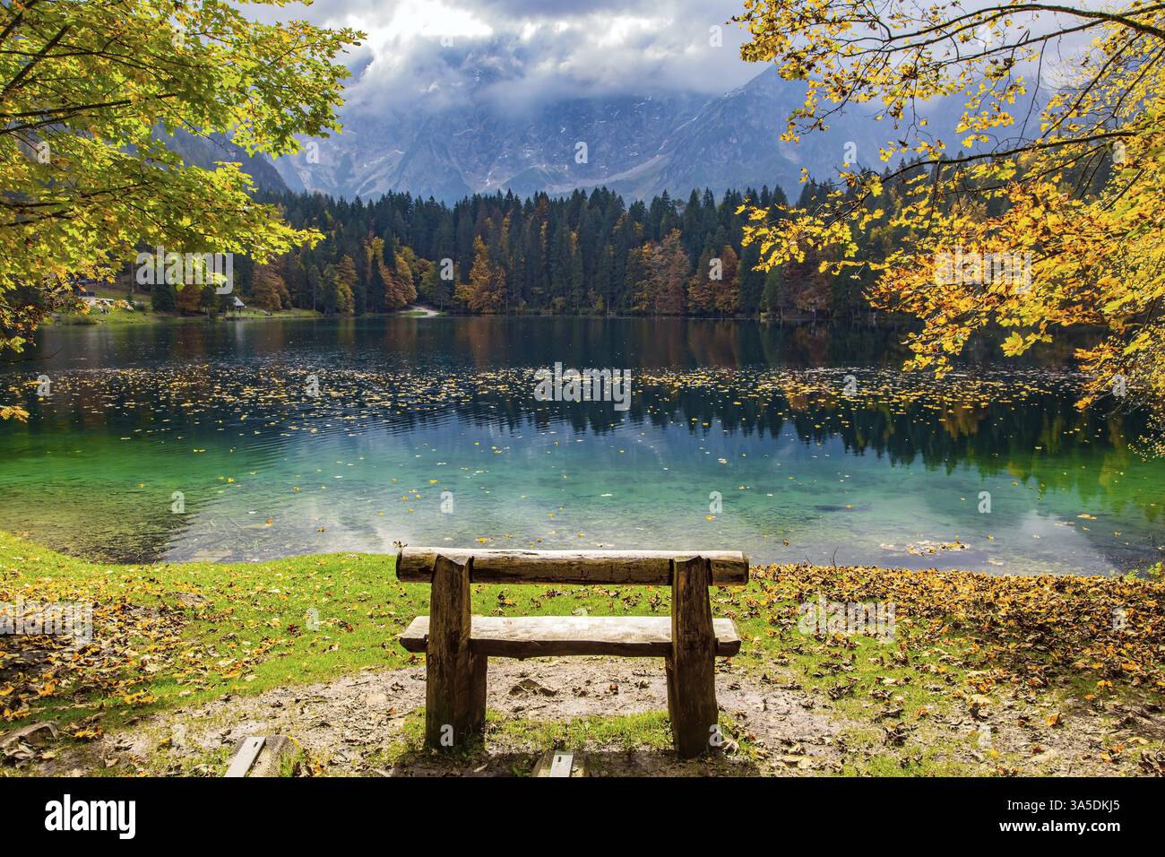 The Lago Fusine of glacial origin in Northern Italy. Picturesque wooden ...