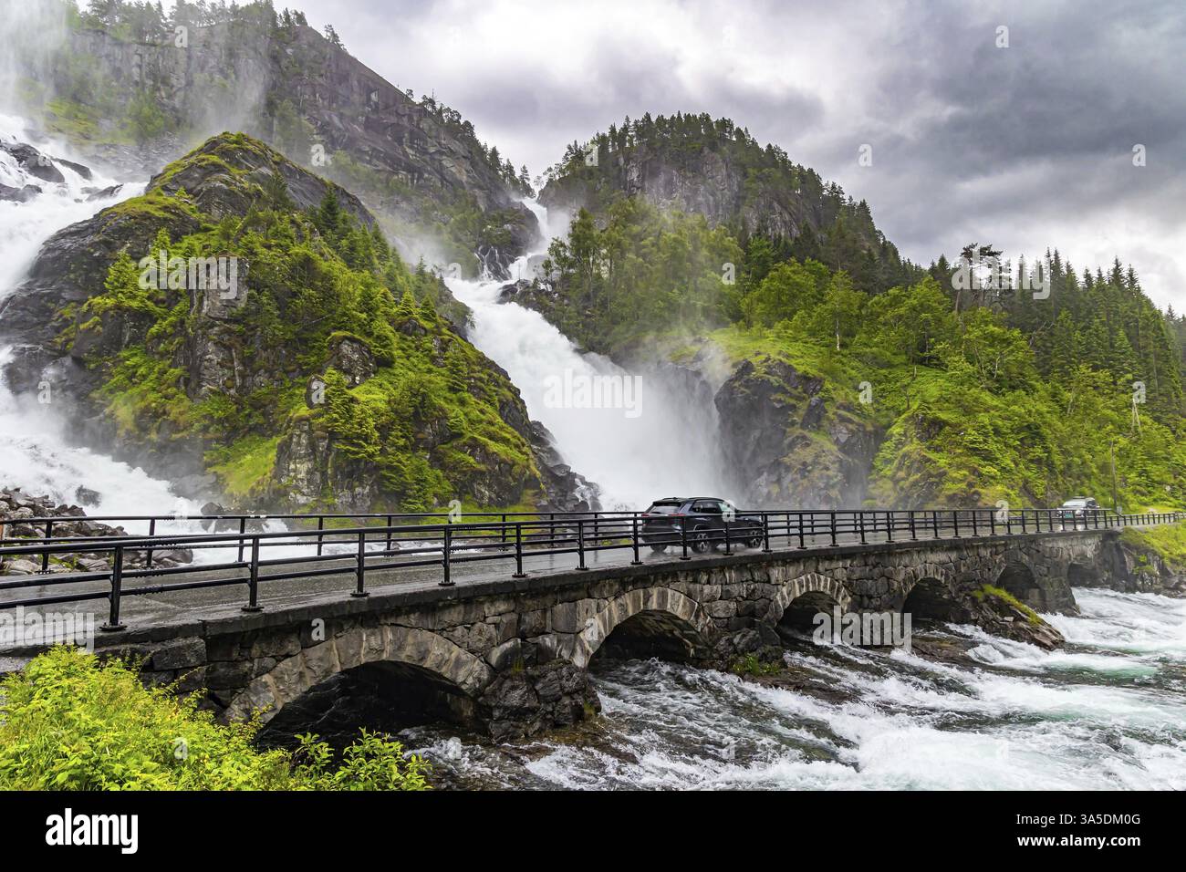 Powerful double waterfall Lotefossen. July rainy day. The waterfall is ...