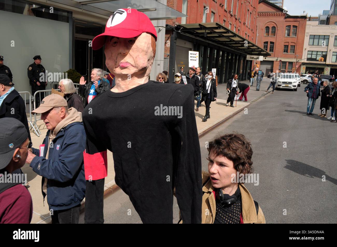 An anti-Elon Musk demonstrator holds a puppet of Elon Musk outside of a ...