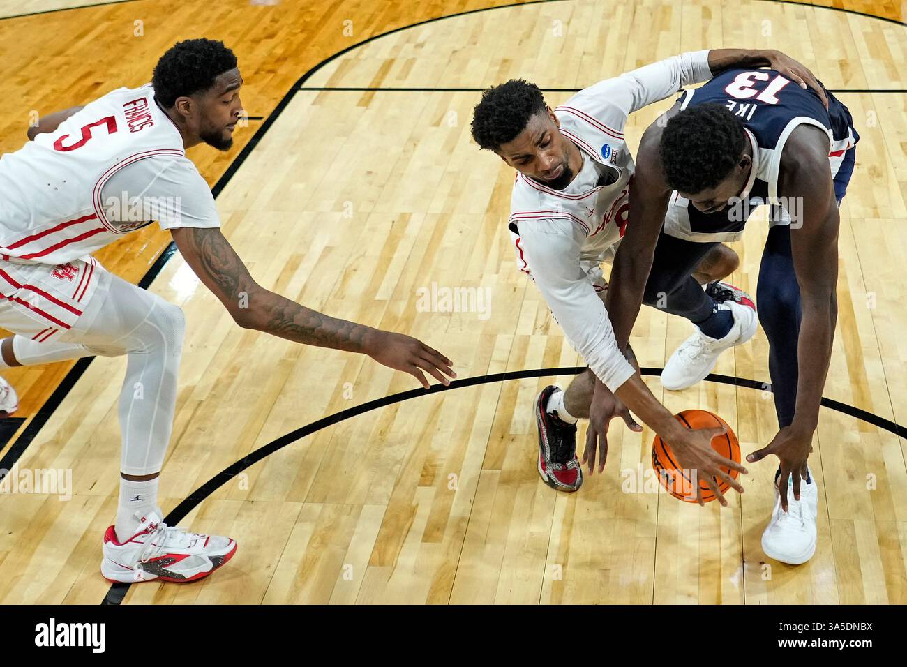 Houston guard Mylik Wilson, center, tries to steal the ball from ...