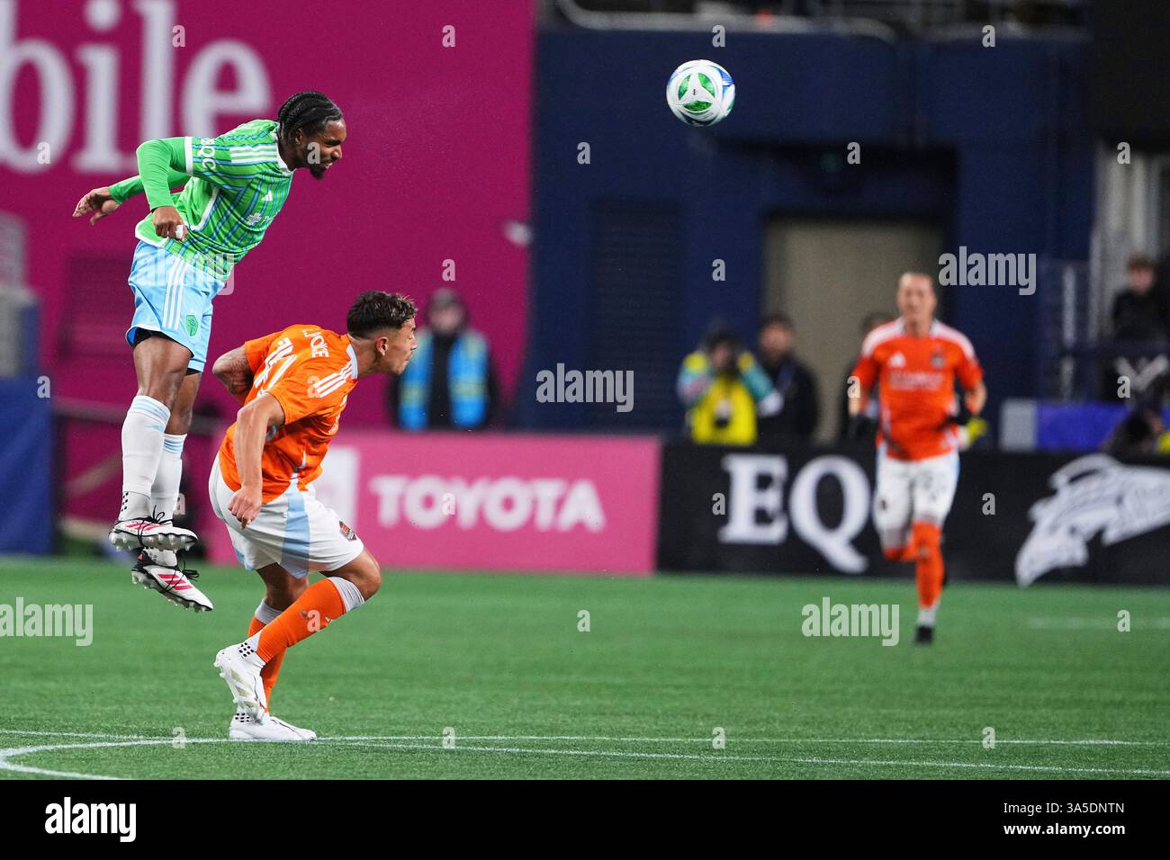Seattle Sounders defender Jon Bell heads the ball against Houston ...