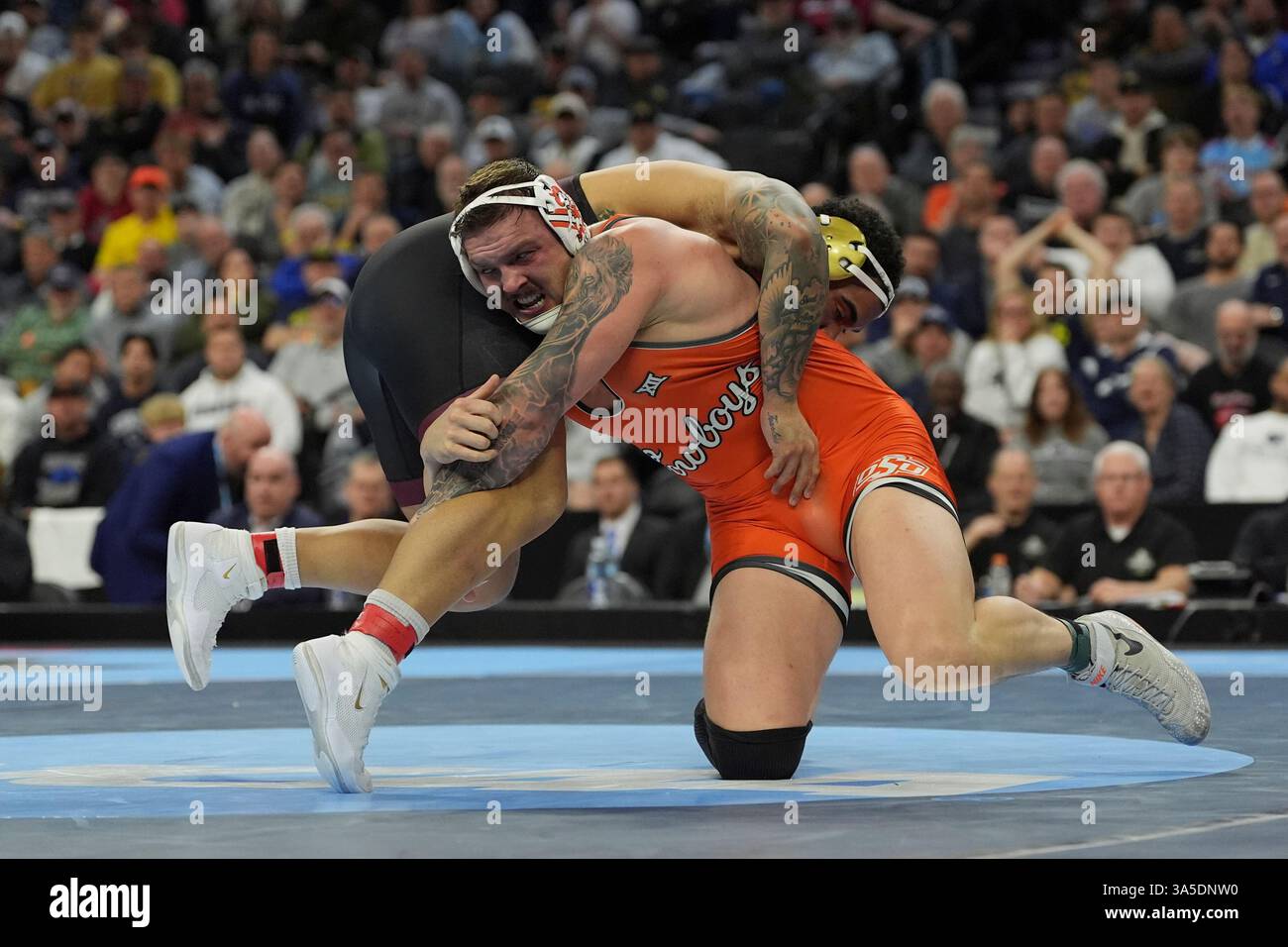 Oklahoma State's Wyatt Hendrickson, bottom, takes on Minnesota's Gable ...