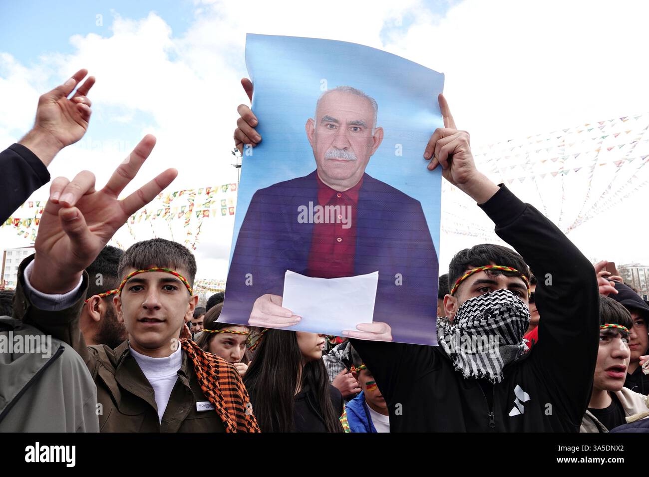 A young demonstrator is seen carrying a poster of PKK leader Abdullah ...