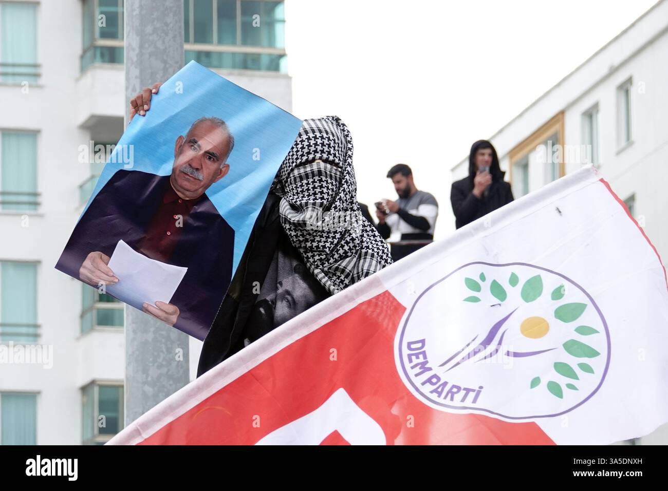 A young demonstrator is seen carrying a poster of PKK leader Abdullah ...