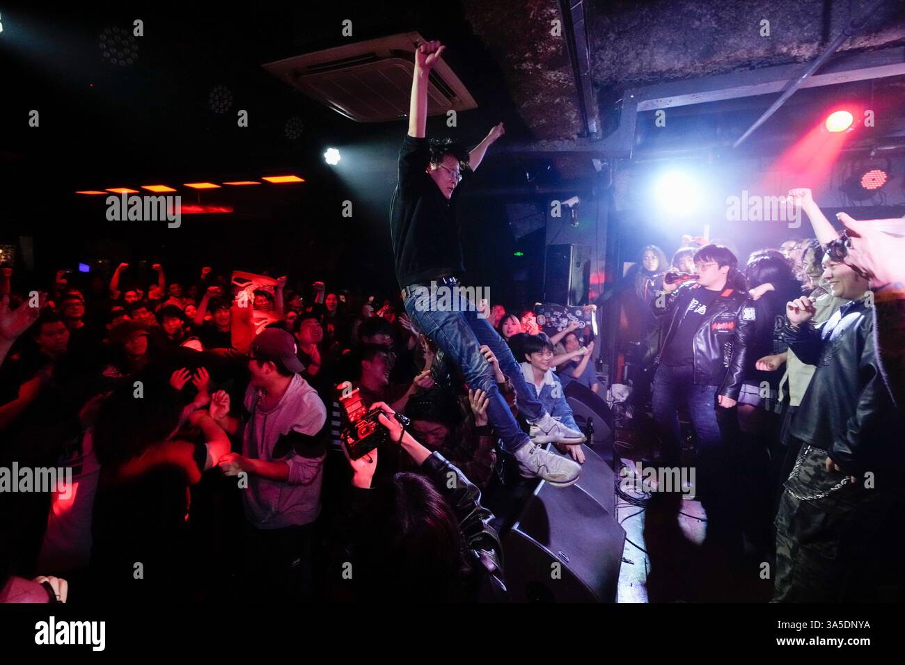 A Chinese punk stage dives to the crowd during a punk festival in ...