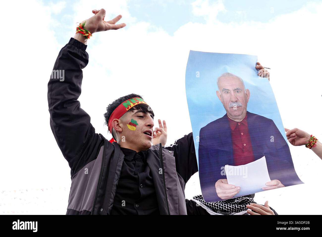 A young demonstrator is seen carrying a poster of PKK leader Abdullah ...