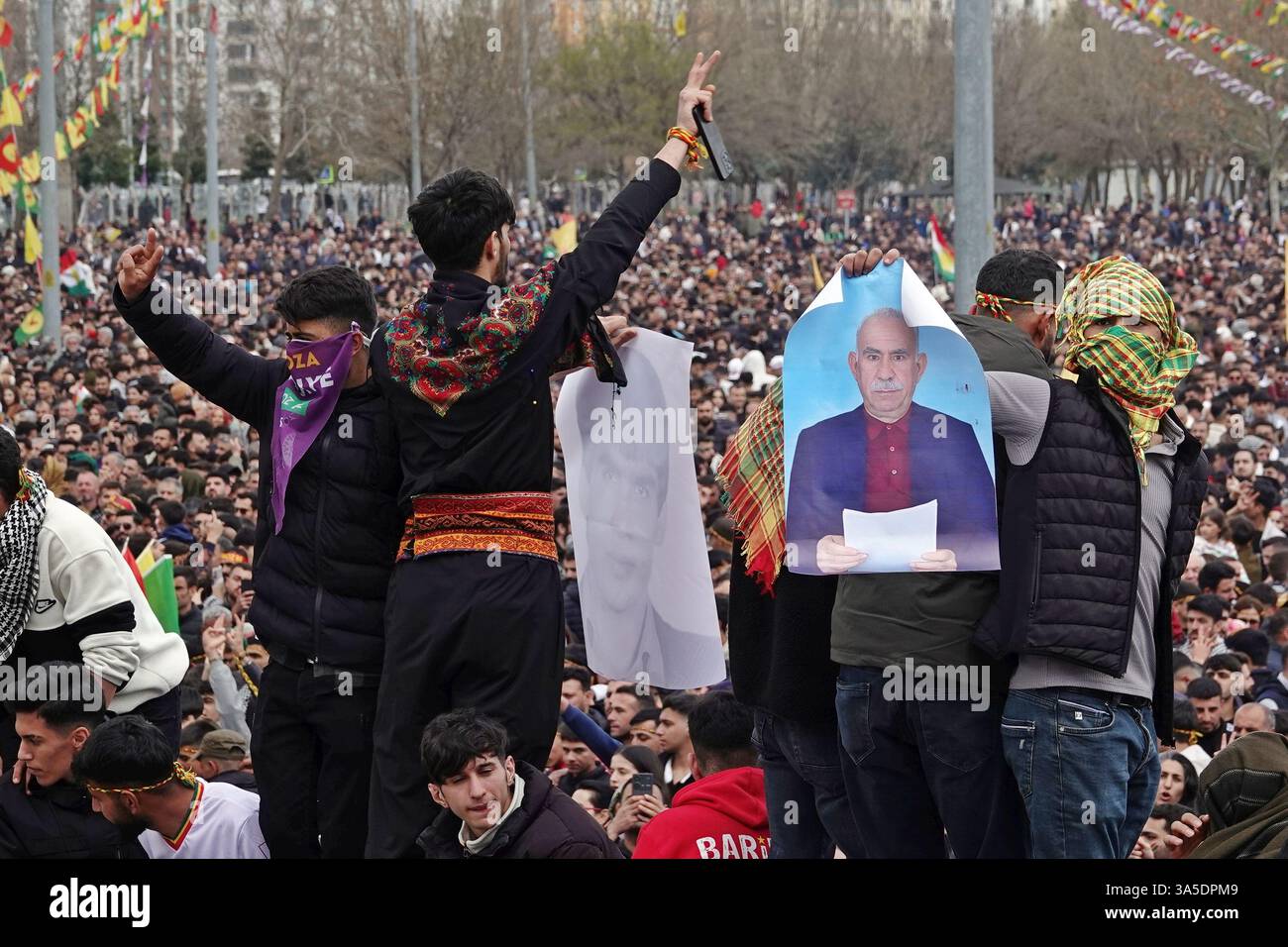 A young demonstrator is seen carrying a poster of PKK leader Abdullah ...