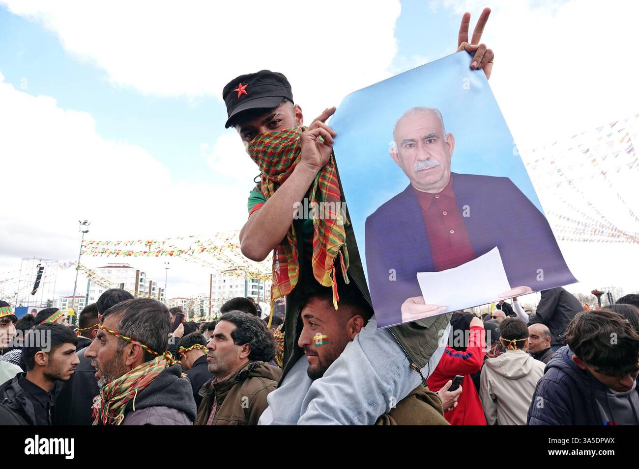 A young demonstrator is seen carrying a poster of PKK leader Abdullah ...