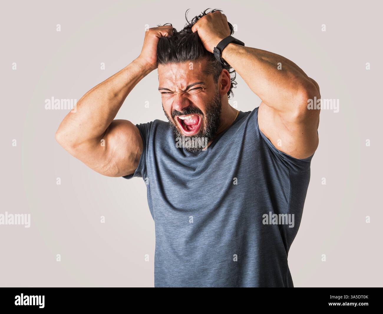 Muscular man posing with angry, frustrated expression screaming ...
