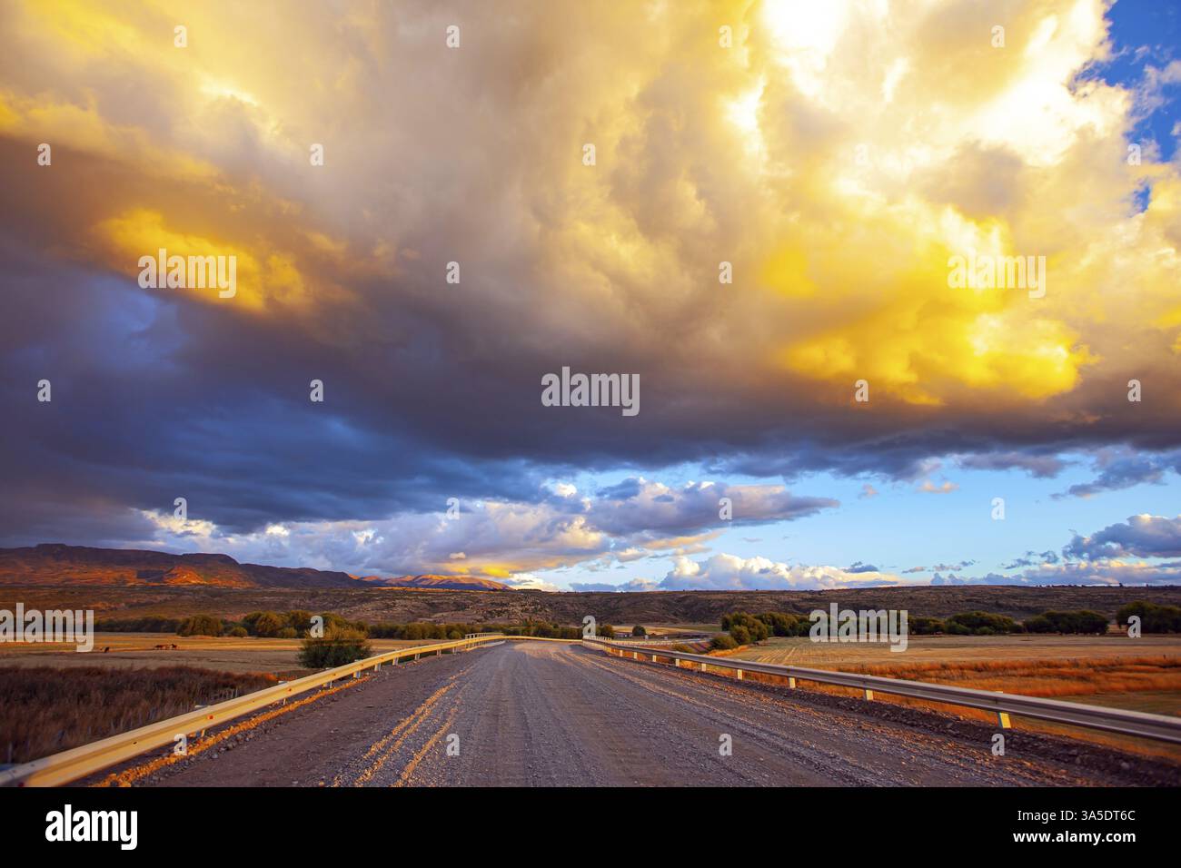 Gigantic scenic thundercloud illuminated by the sunset. The steppe is ...