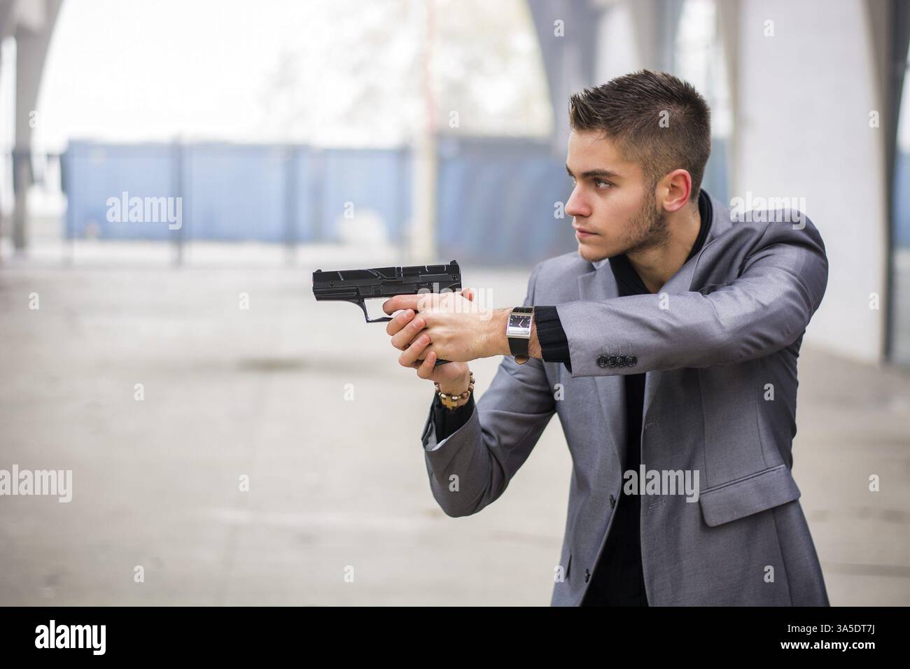 Well dressed handsome young detective or policeman or mobster standing ...