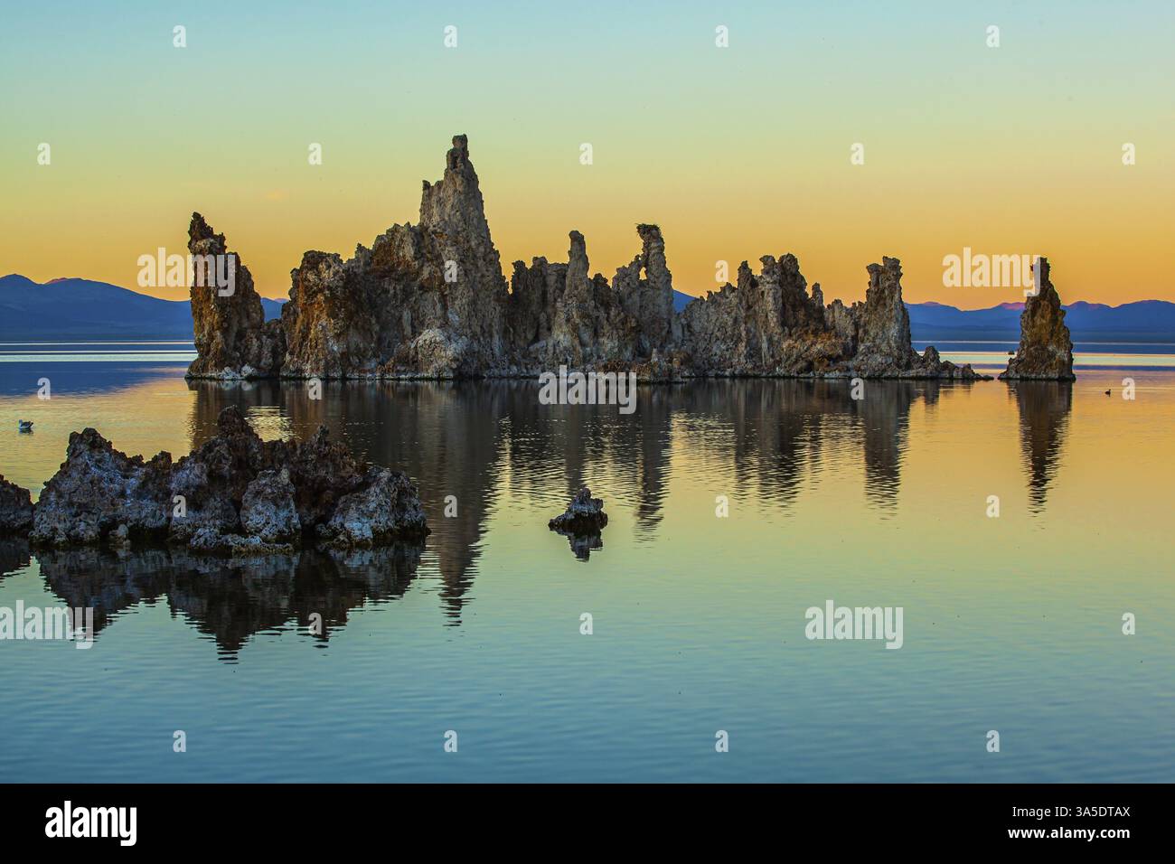 Magic sunset on the lake. Magnificent reflections of tuff outliers in ...