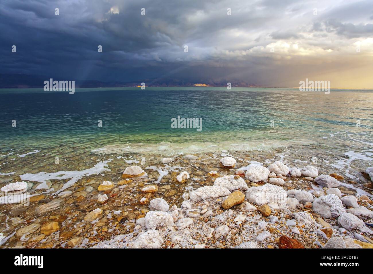 Rocky beach covered with evaporated salt. Israeli coast. Gloomy sky ...