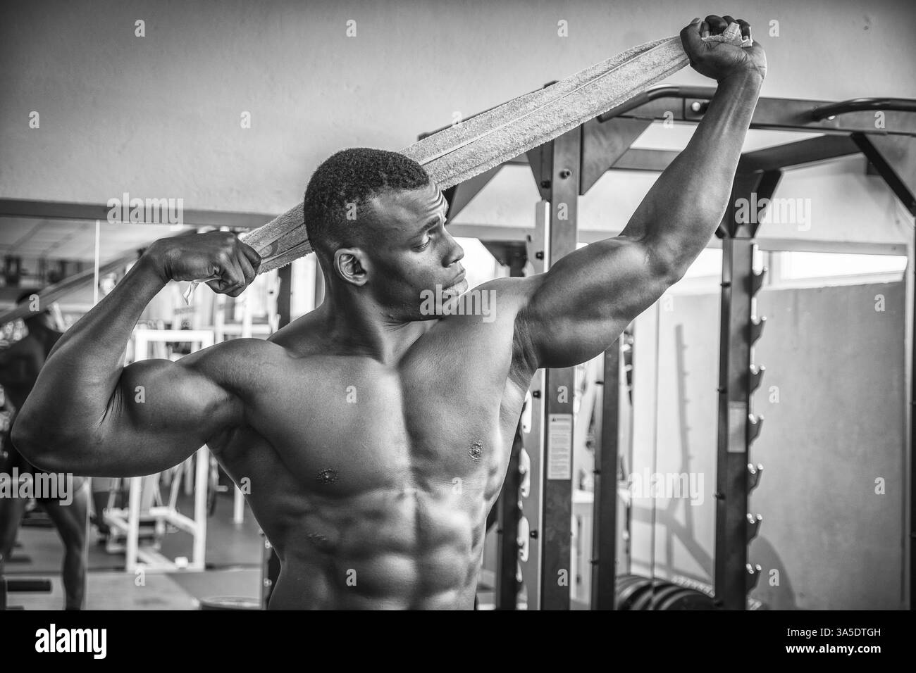 Attractive hunky black male bodybuilder doing bodybuilding pose in gym ...