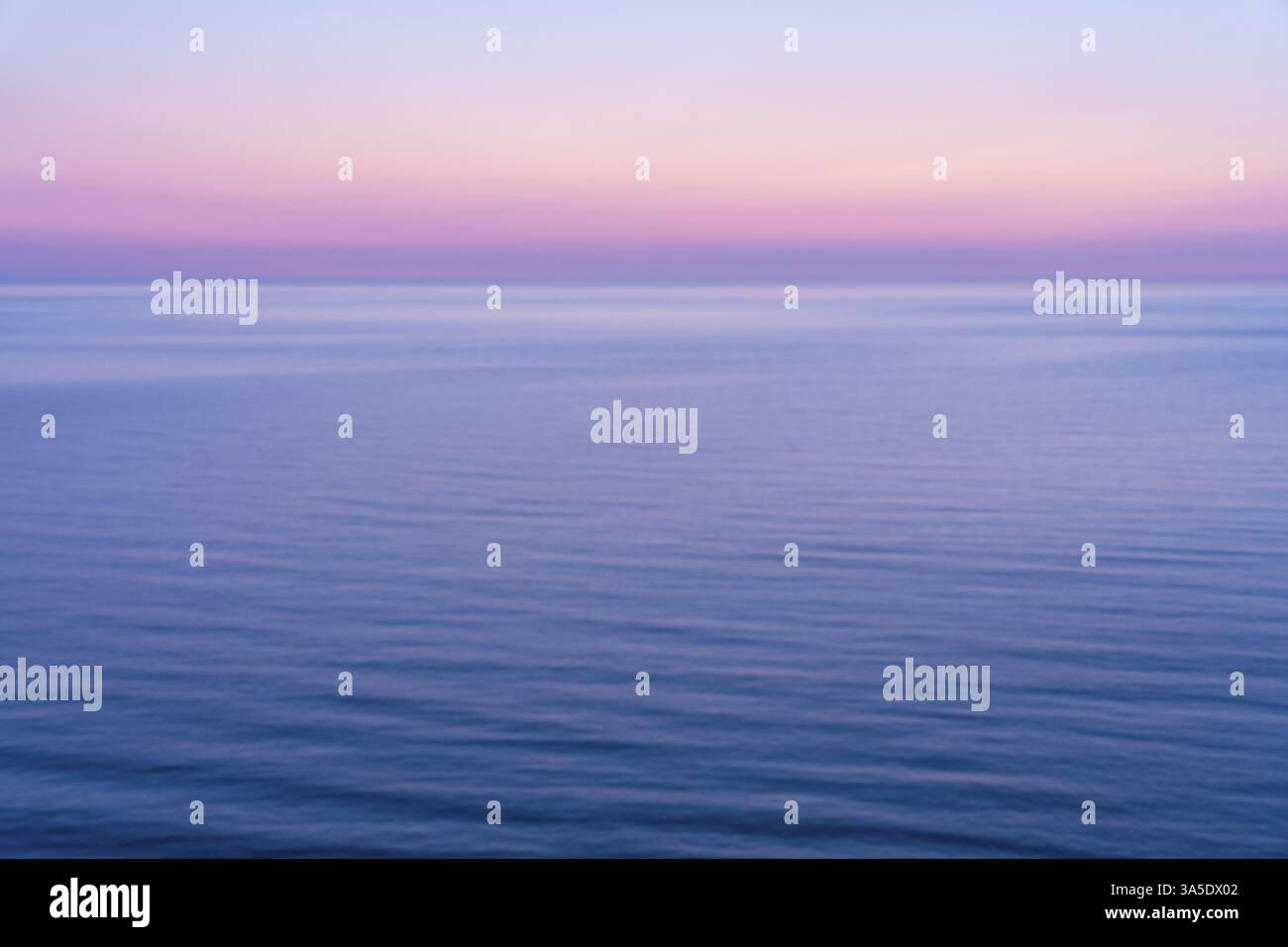The sea with a pastel-coloured sky after sunset. Blurred, ICM ...