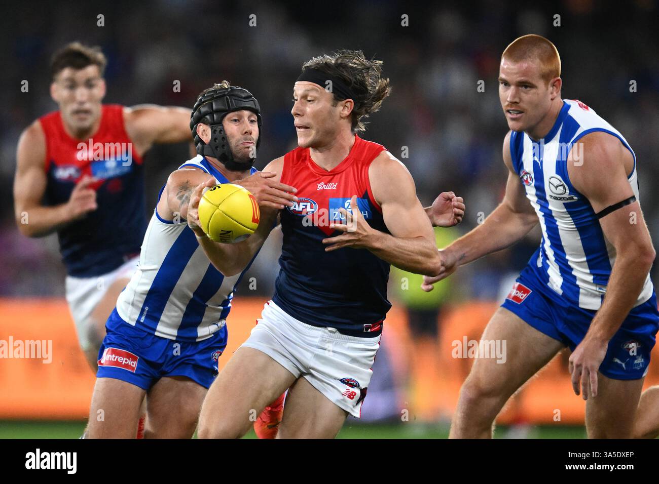 Caleb Daniel of North Melbourne (left) and Ed Langdon of the Demons ...