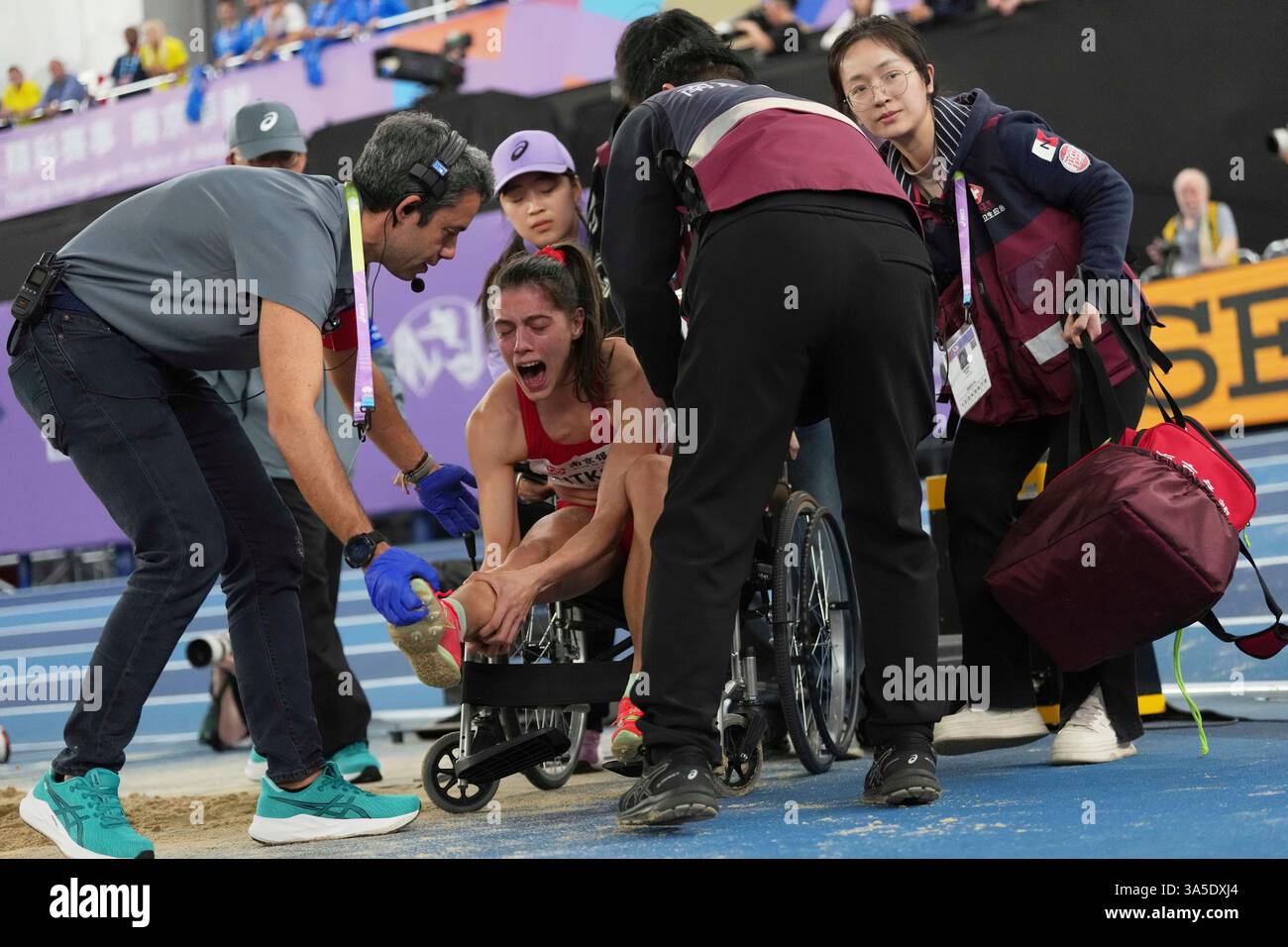 Plamena Mitkova of Bulgaria reacts in pain as she is taken away by the ...