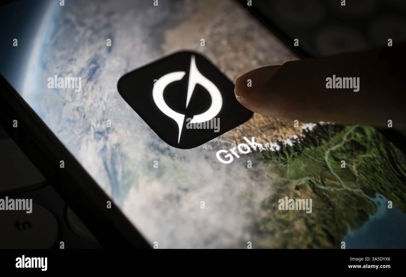 In this photo illustration, a person uses Grok AI chatbot on a mobile ...