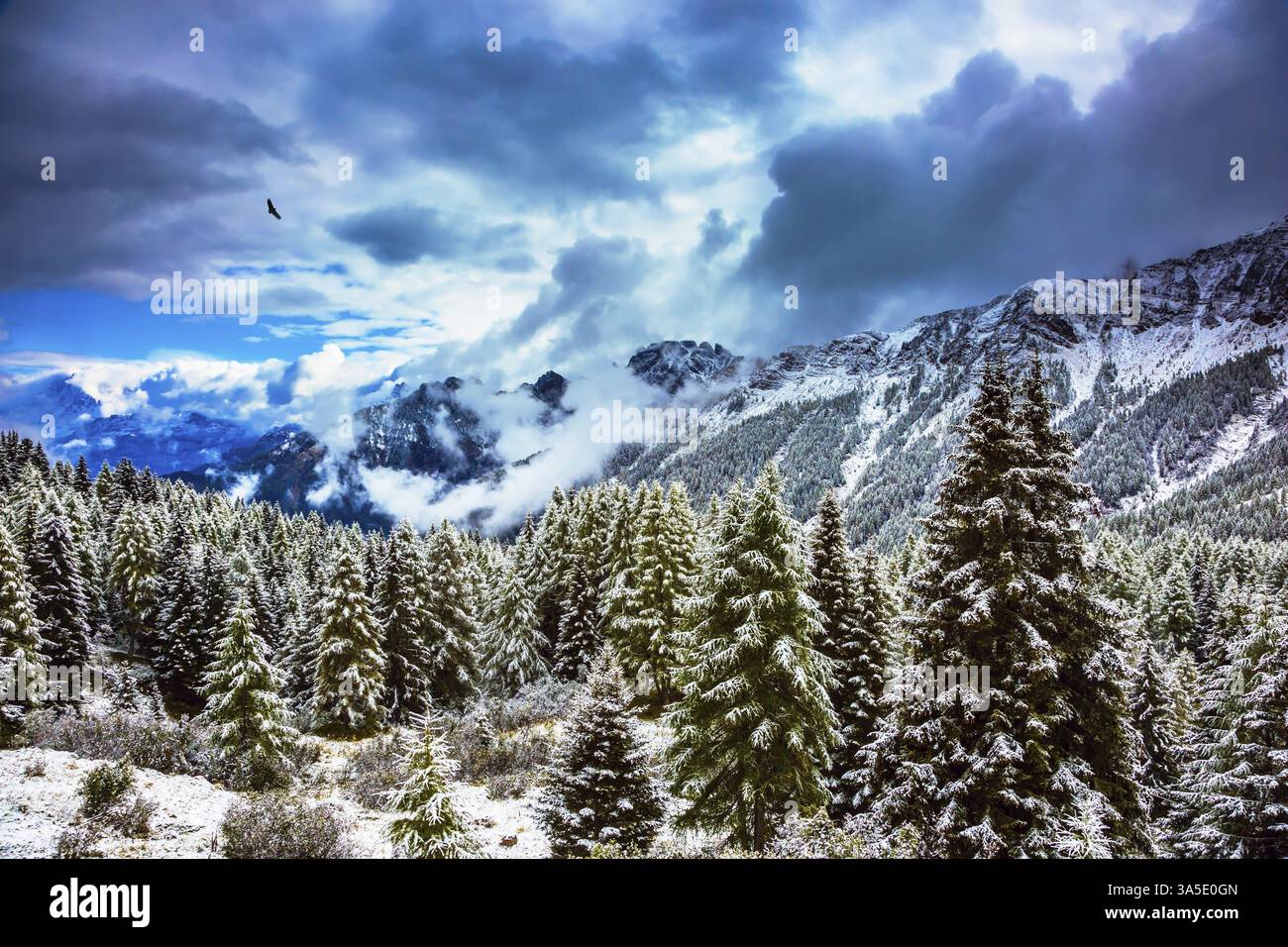 The magnificent landscape of the Dolomites in snow. Heavy rain clouds ...