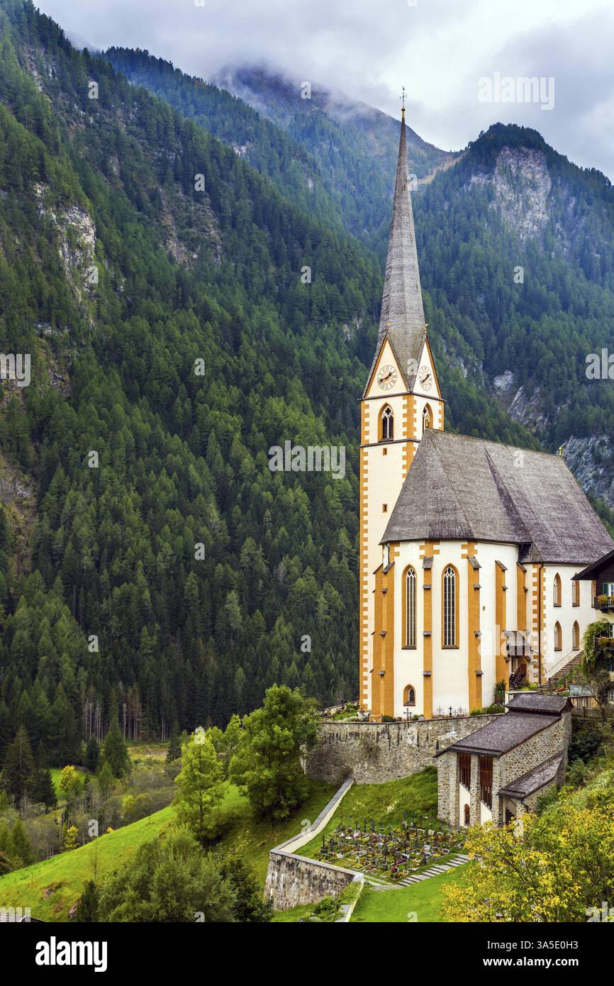 Spring in the Austrian Alps. Gothic church of St. Vincenzo. The village ...