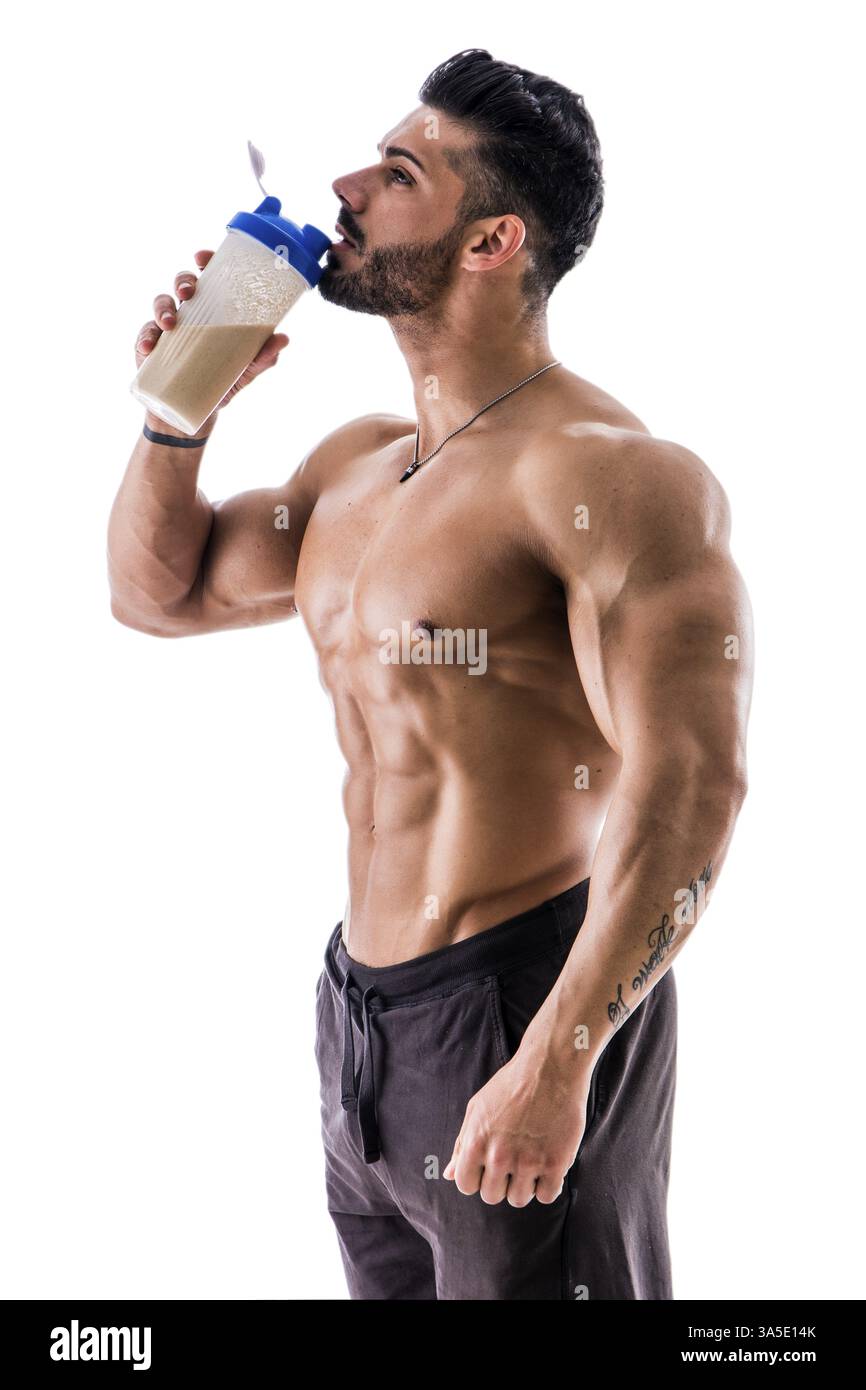 Handsome muscular man posing with protein blender in his hands ...