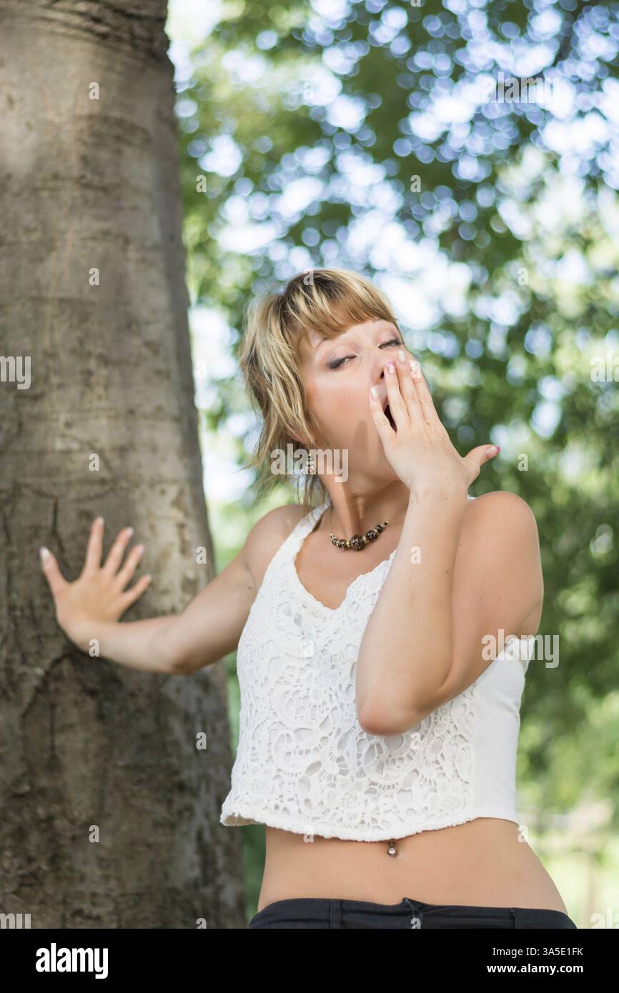 Bored young woman stands hi-res stock photography and images - Alamy