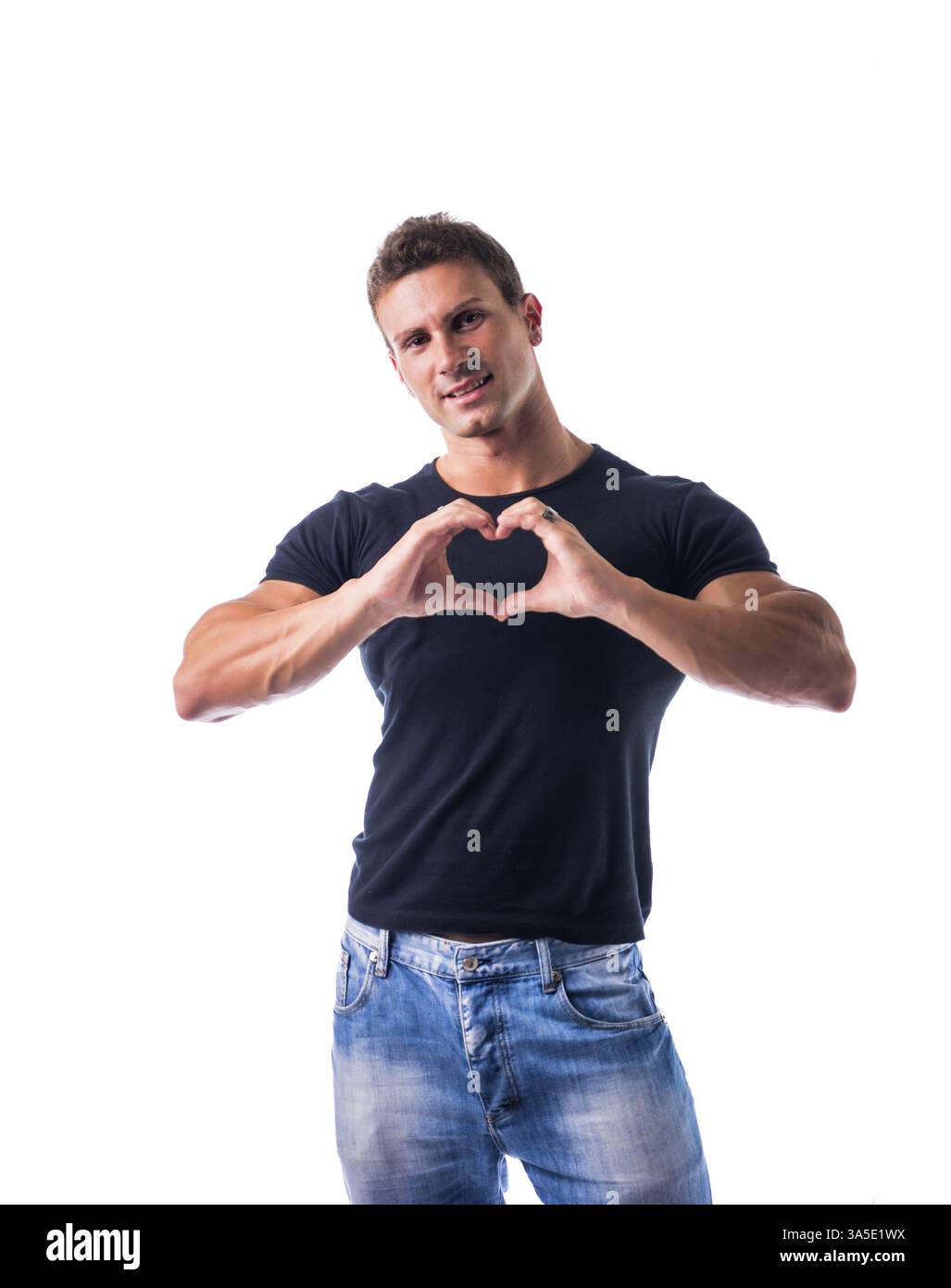 Handsome young man making heart sign with his hands and fingers. Studio ...