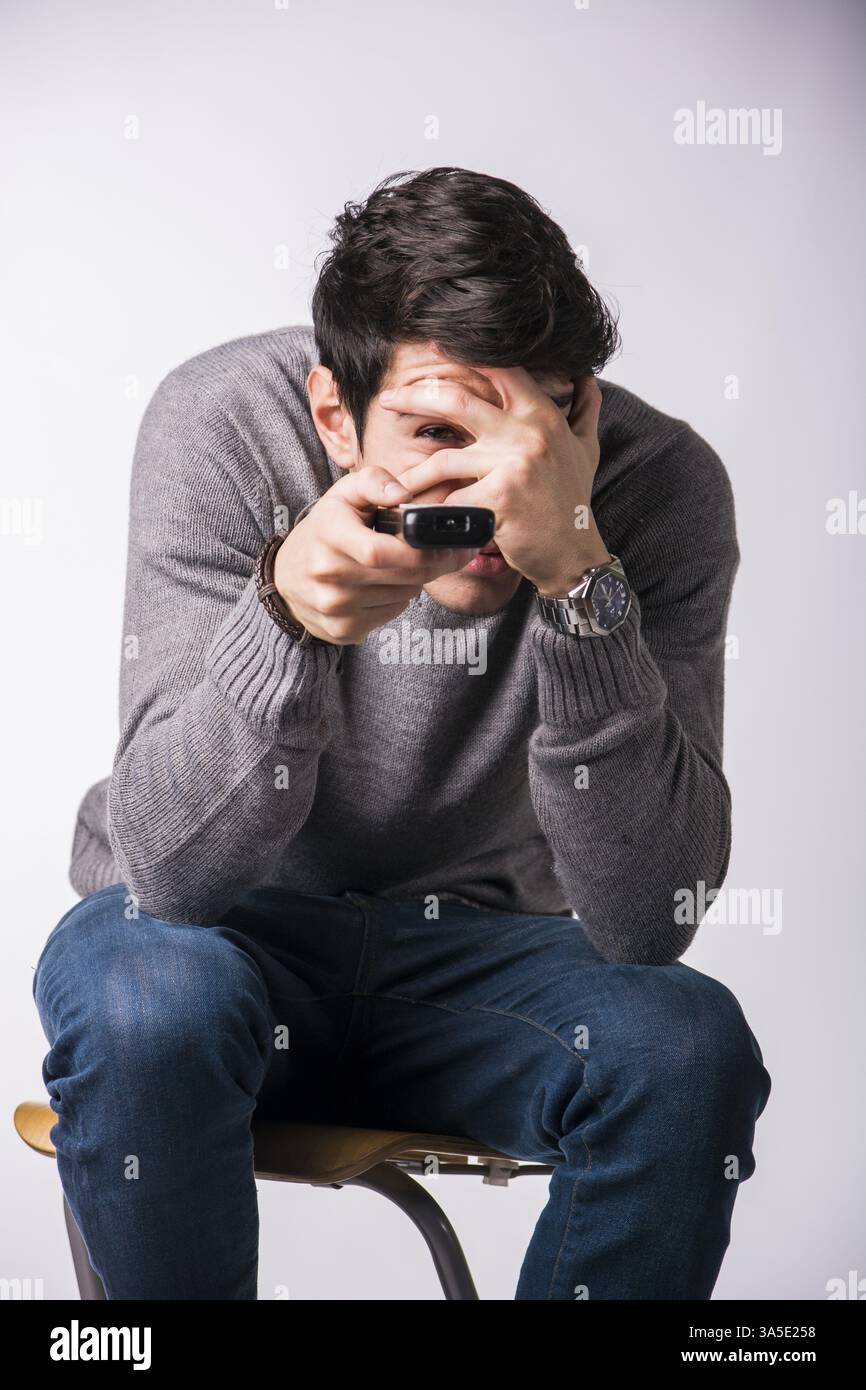 Covering his eyes scared sitting isolated on white hi-res stock ...