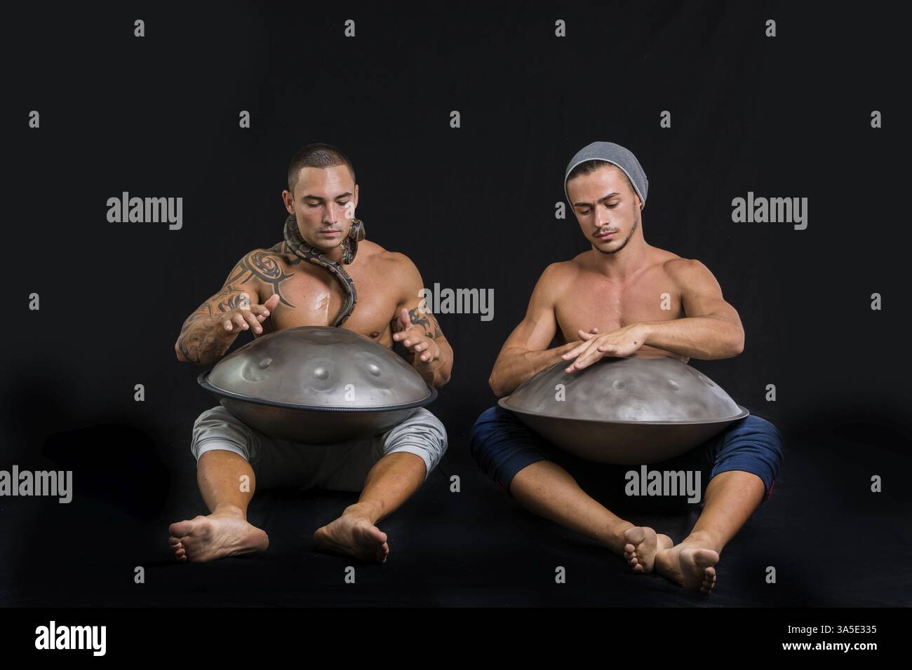 Two Exotic Male Drummers Drumming with Hands on Steel Pan Drums While ...