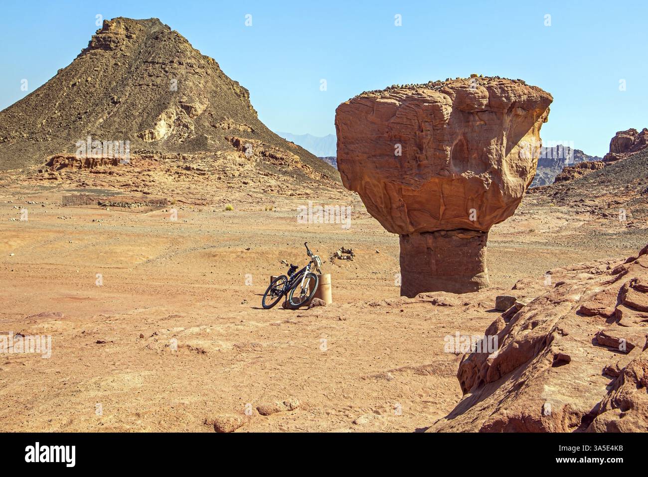 Abandoned bike. Red sandstone rock Mushroom. Magnificent multi-colored rock. Israel. The Timna ...