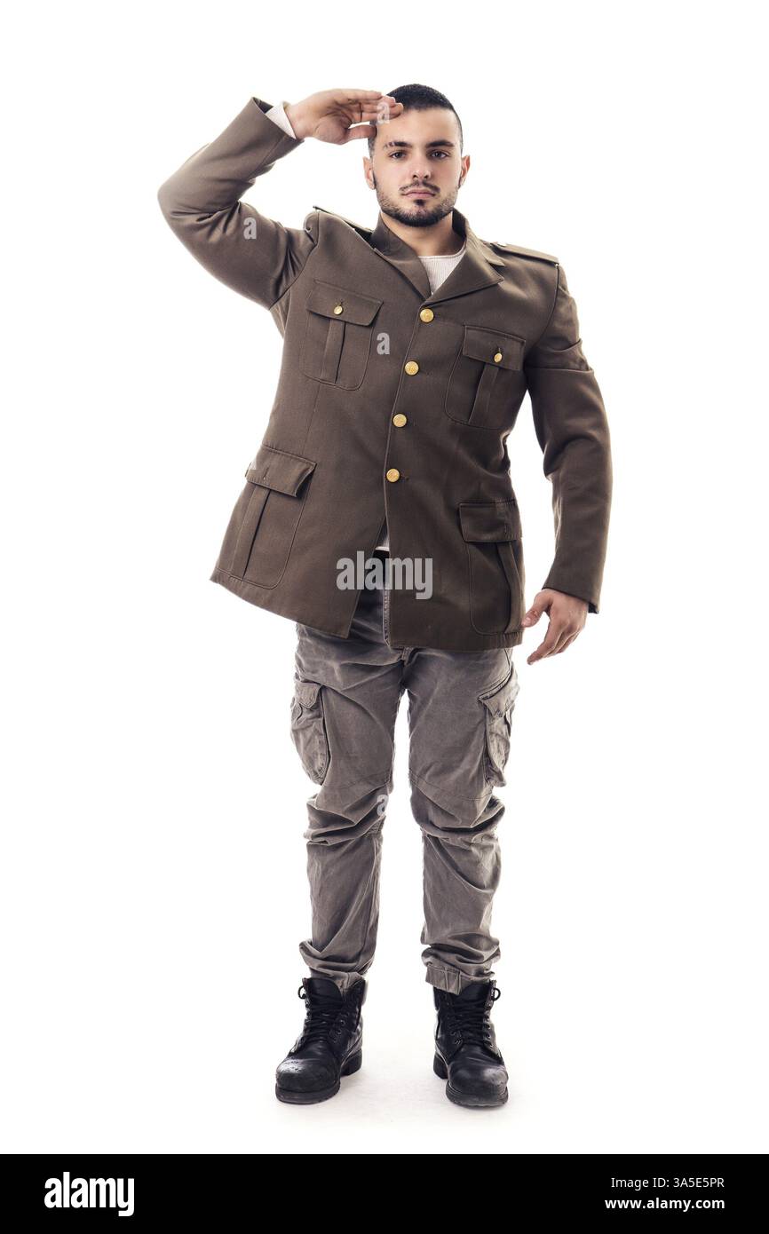 Bearded man saluting while wearing military uniform.Studio shot ...