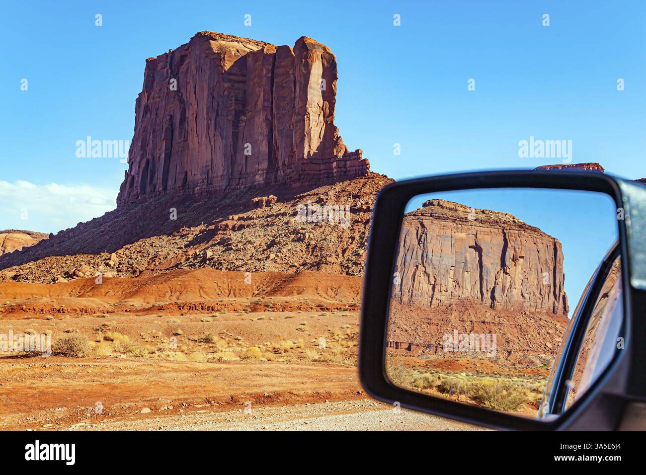 The car mirror reflects the scenic landscape. The famous colossal rock ...