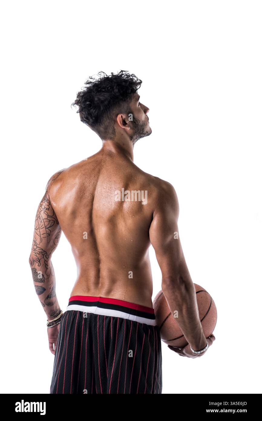 Young athletic man isolated on white background holding basketball ball ...
