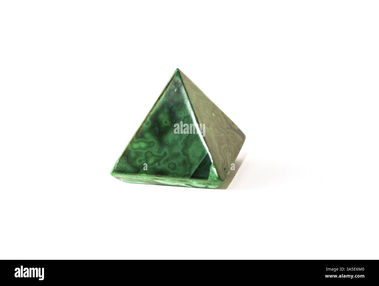 Beautiful malachite pyramid, cut mineral on white background, isolated ...
