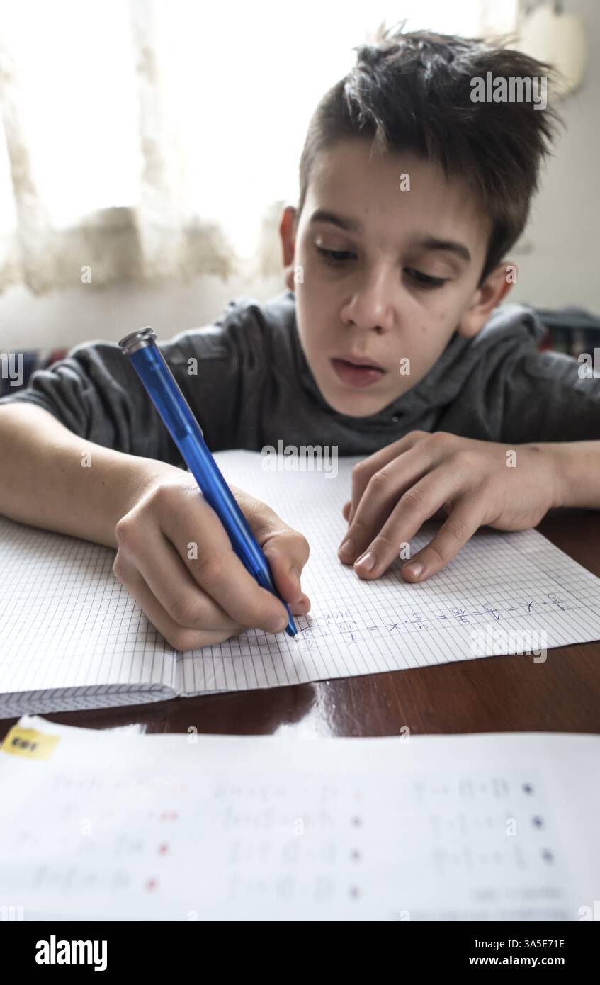Boy do his homework. Notebook Stock Photo - Alamy