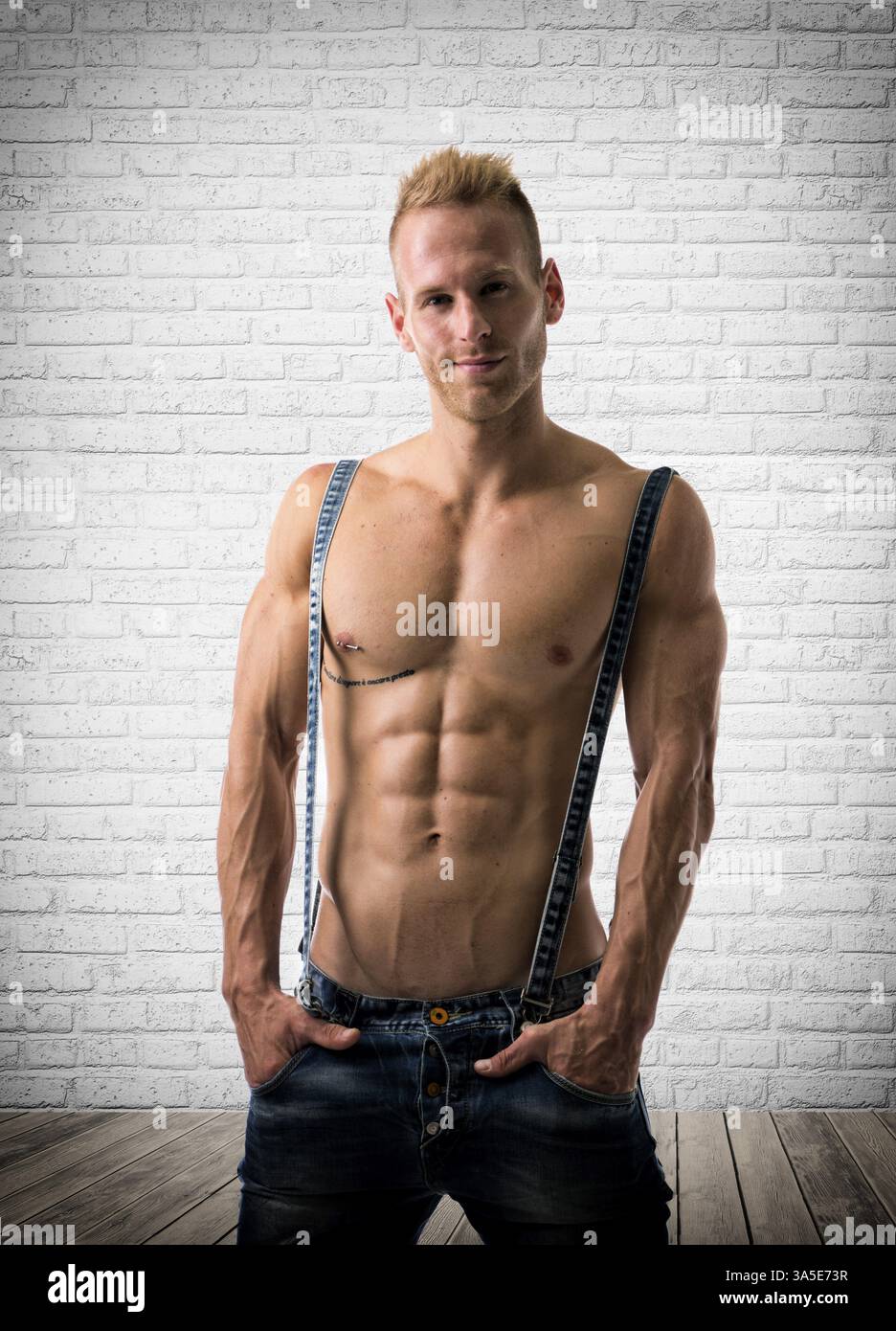 Confident male model with a smirk on his face while showing off his ...