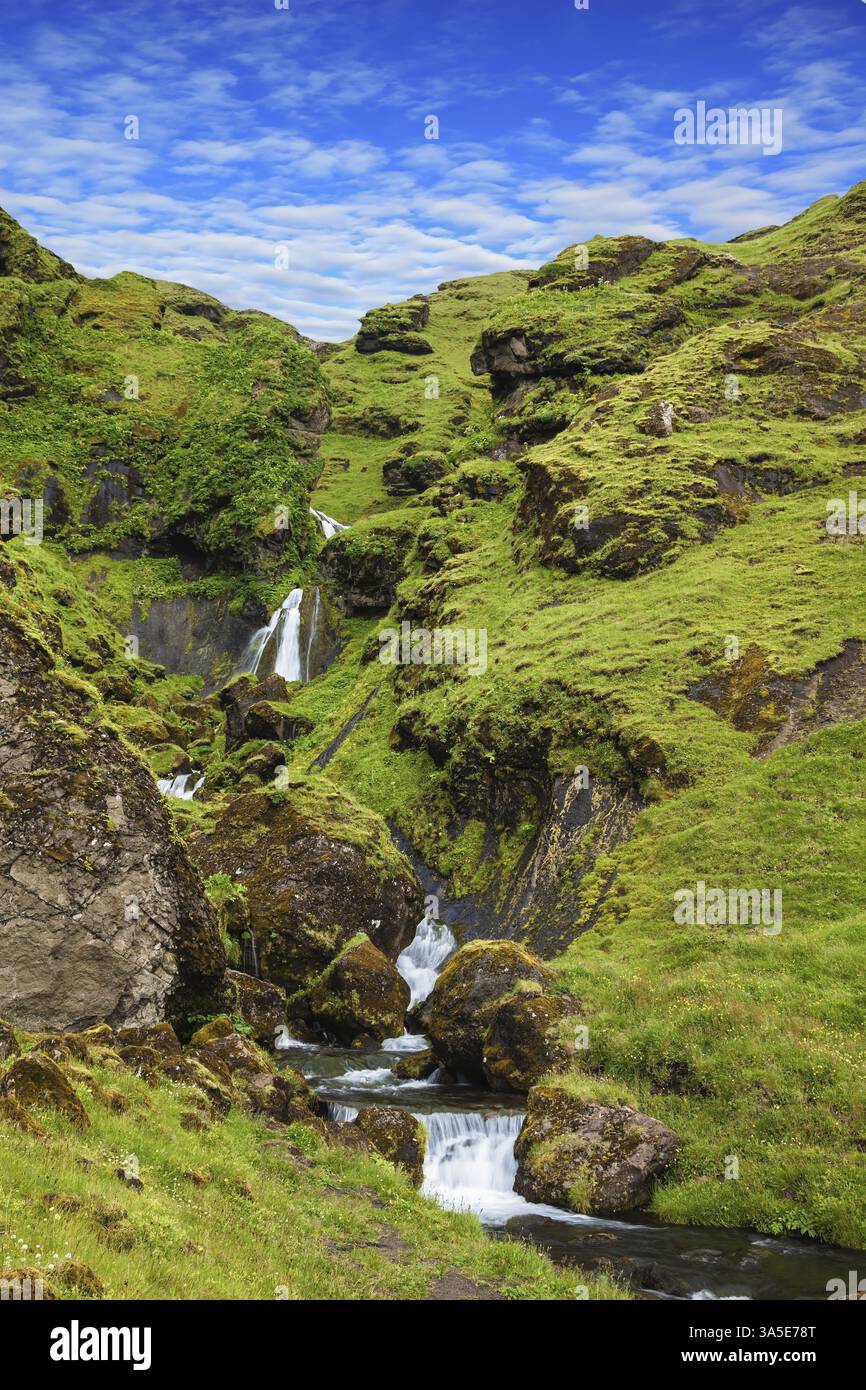 Basalt mountains covered in green moss and grass . Gorgeous cascading ...