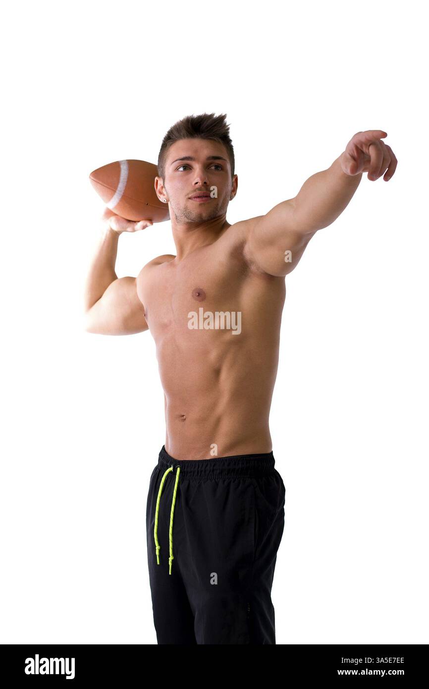 Muscular american football player standing with ball in hand, seen from ...