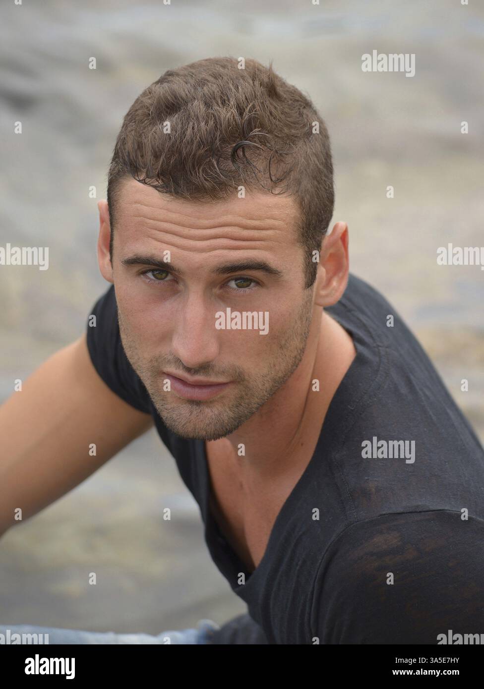 Attractive young man looking up, shot from above Stock Photo - Alamy