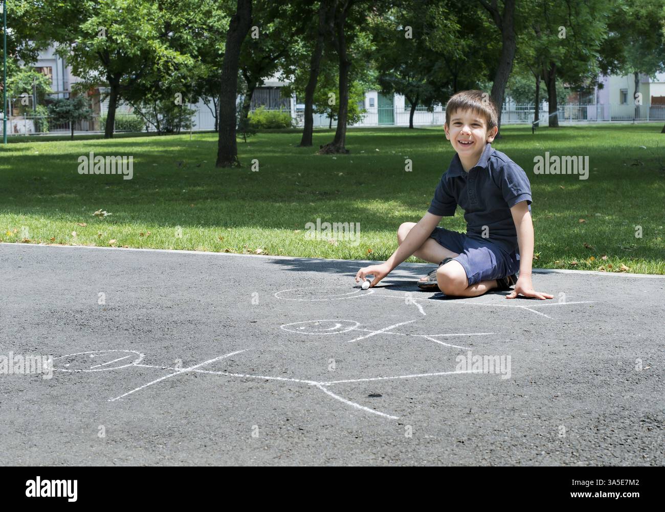 Child drawing family on asphalt in a park Stock Photo - Alamy
