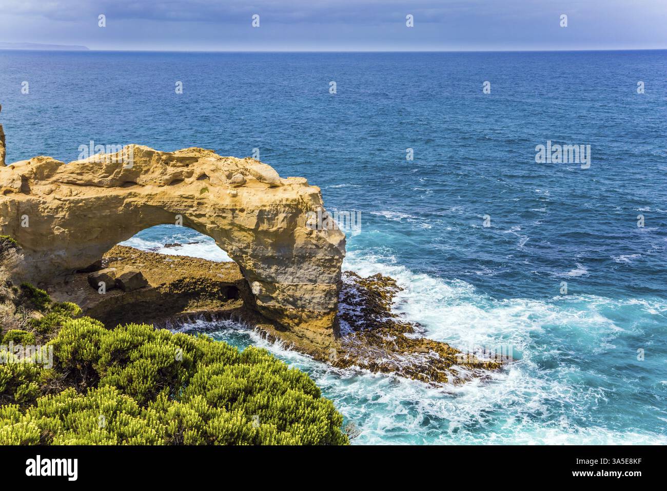 Coastal rocks formed a picturesque arch of sandstone. Pacific ocean ...