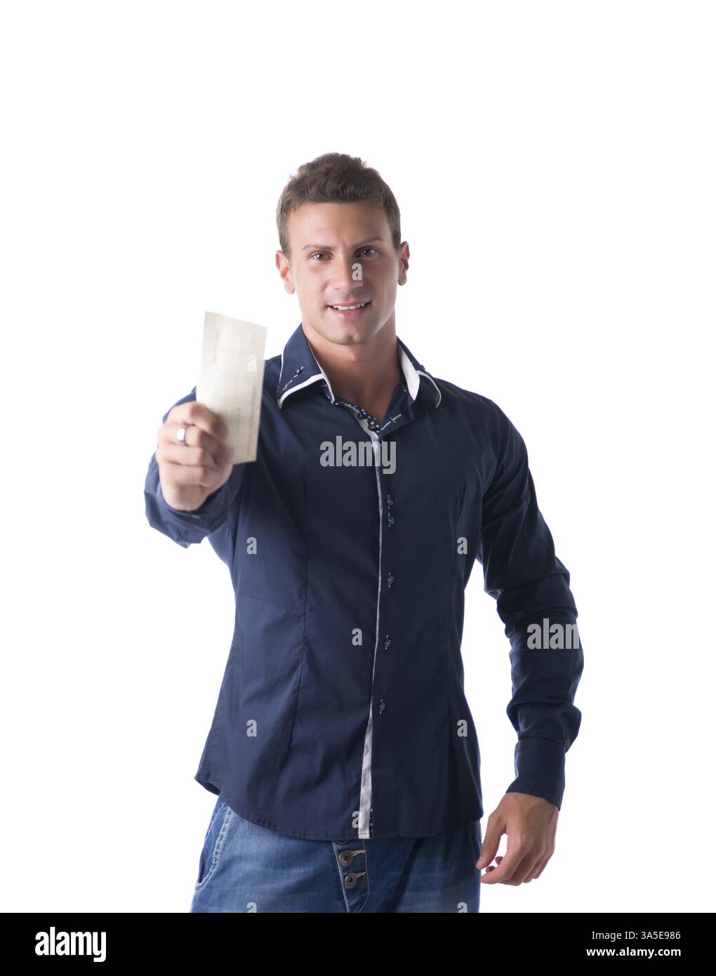 Young man showing check or cheque in his hands, looking at camera ...
