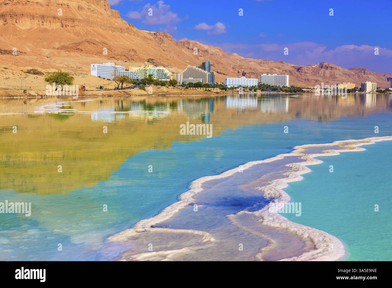 Emerald water of the Dead Sea. Fused salt made on the surface of the ...
