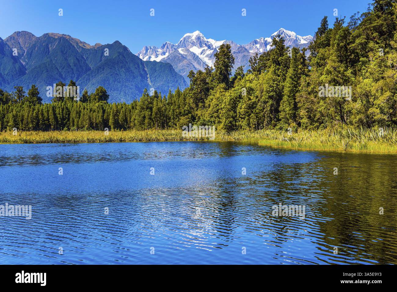 The lake Matheson reflects Mount Cook and Mount Tasman. Lake Matheson ...