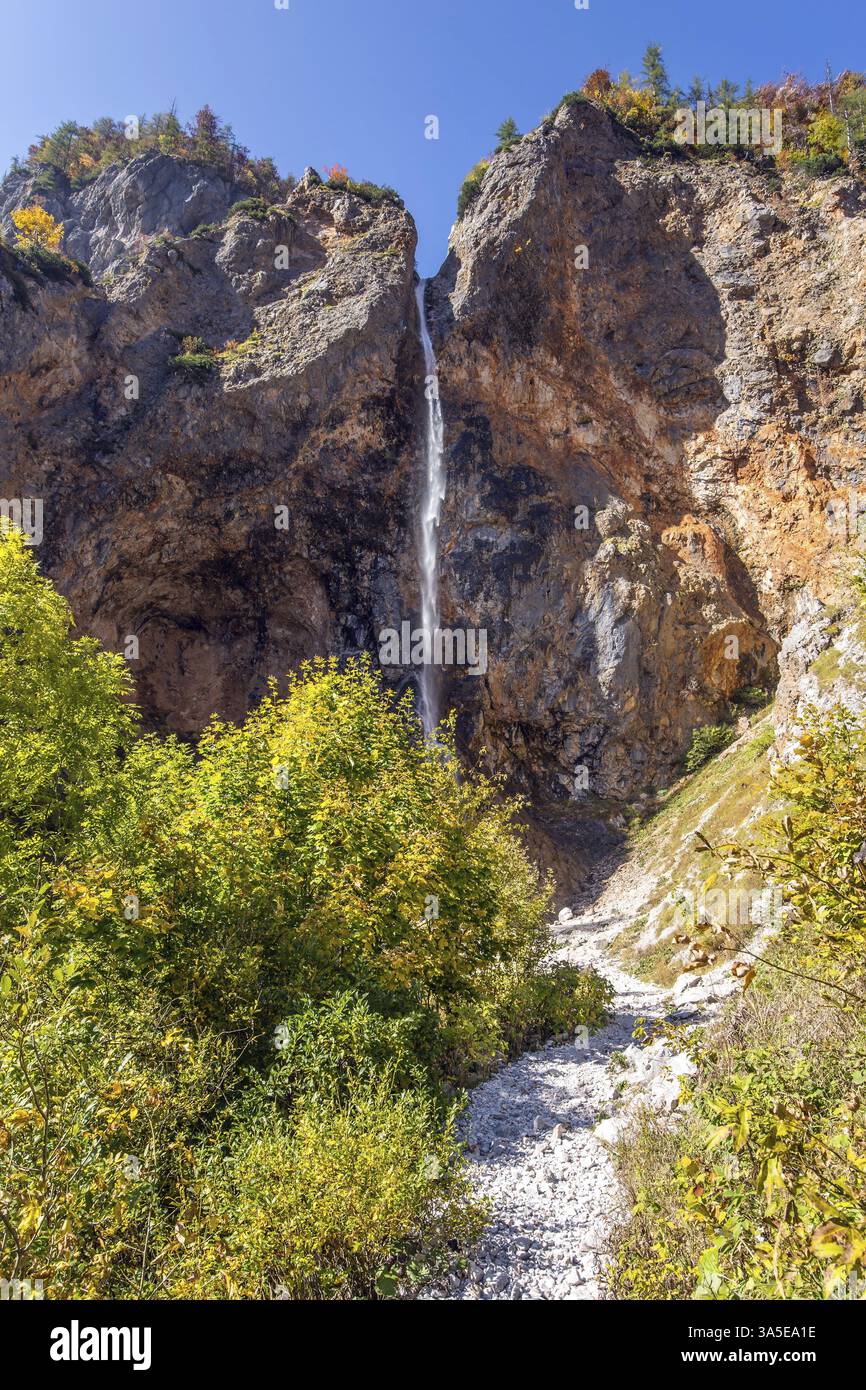Magnificent golden autumn in the mountains. The picturesque Rinka Falls ...